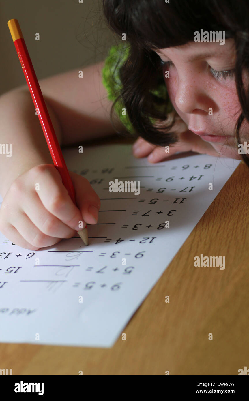 Little girl doing maths homework Stock Photo - Alamy