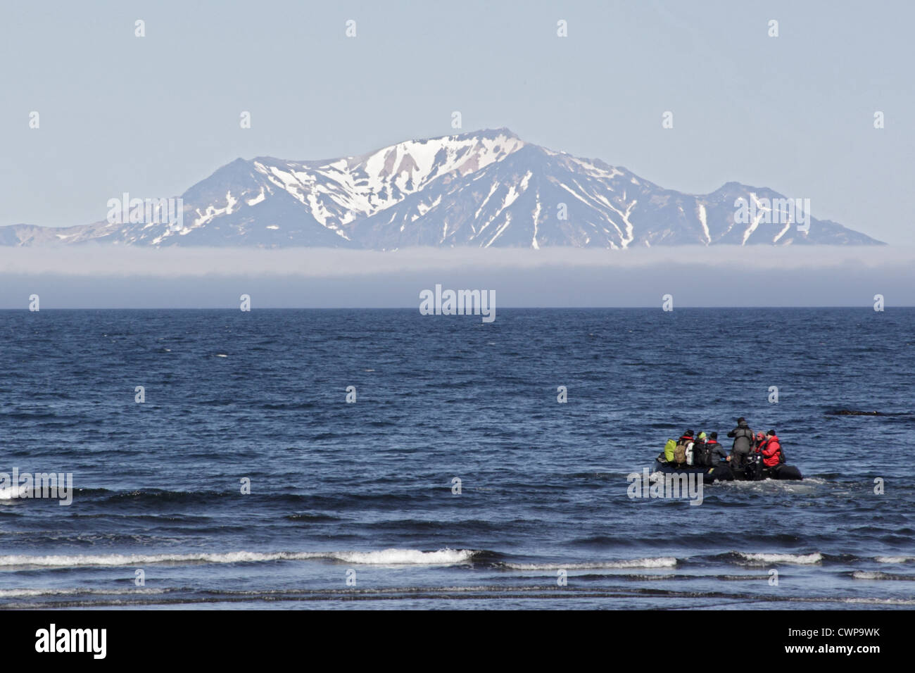 Zodiac inflatable boat with tourists at sea, Onekotan Island, Kuril ...