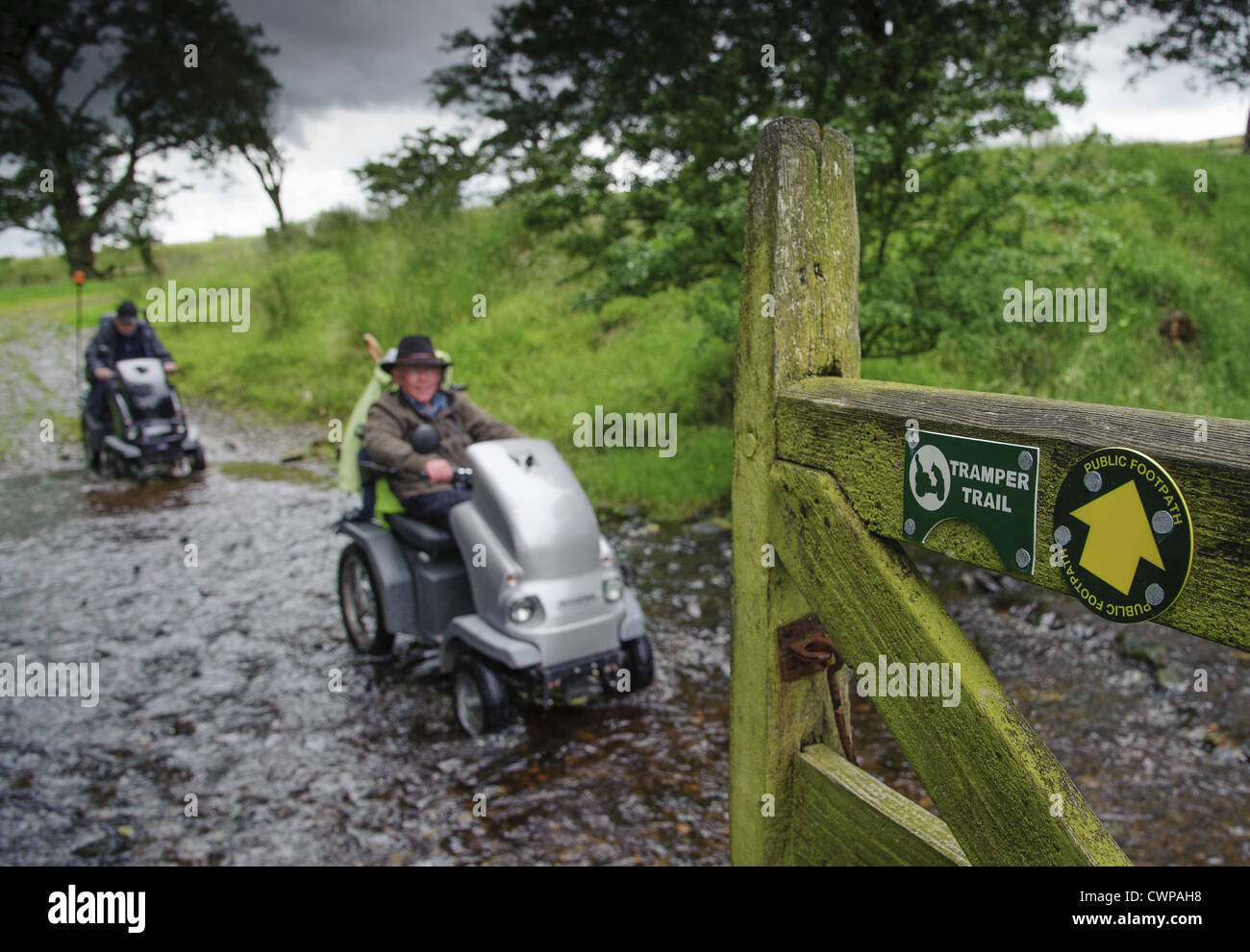 'Tramper Trail' and 'Public Footpath' signs on gate, people with ...