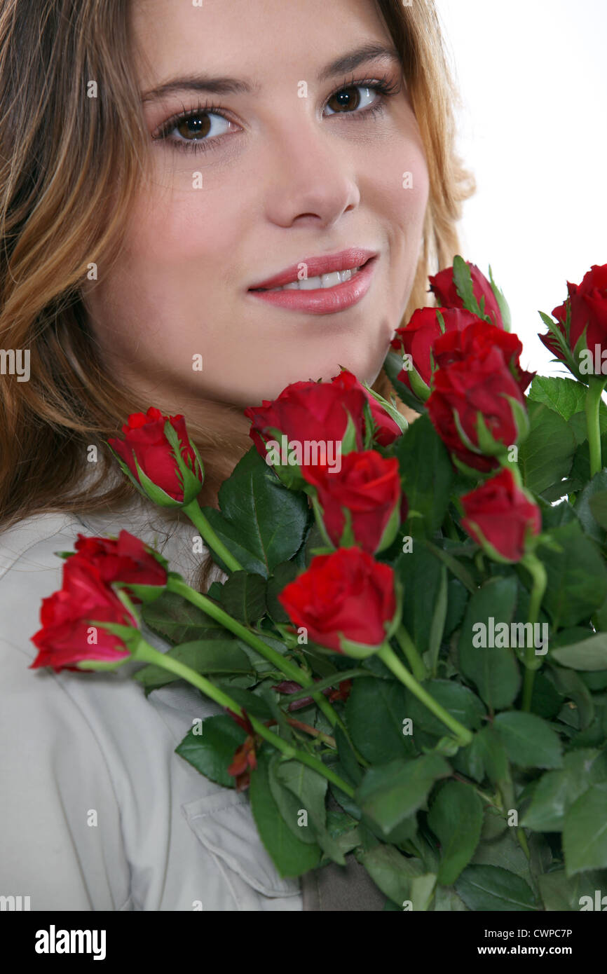 Young woman with a bunch of red roses Stock Photo - Alamy