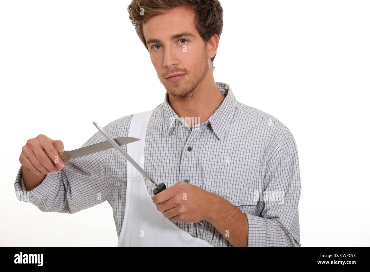 Male chef sharpening knife Stock Photo - Alamy