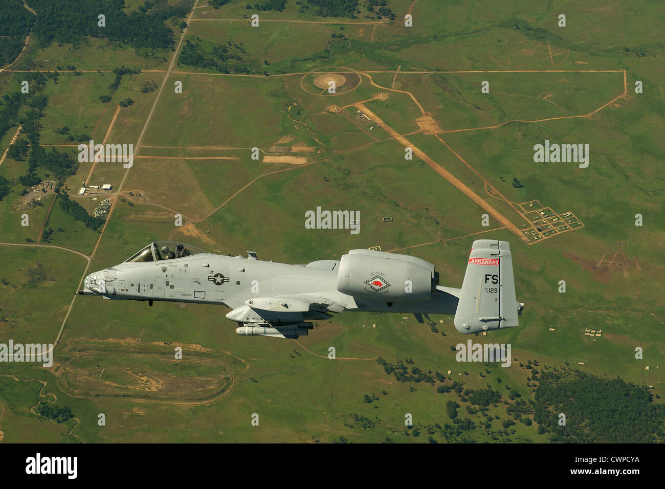 An A-10 Thunderbolt II banks into a high angle firing position during a ...
