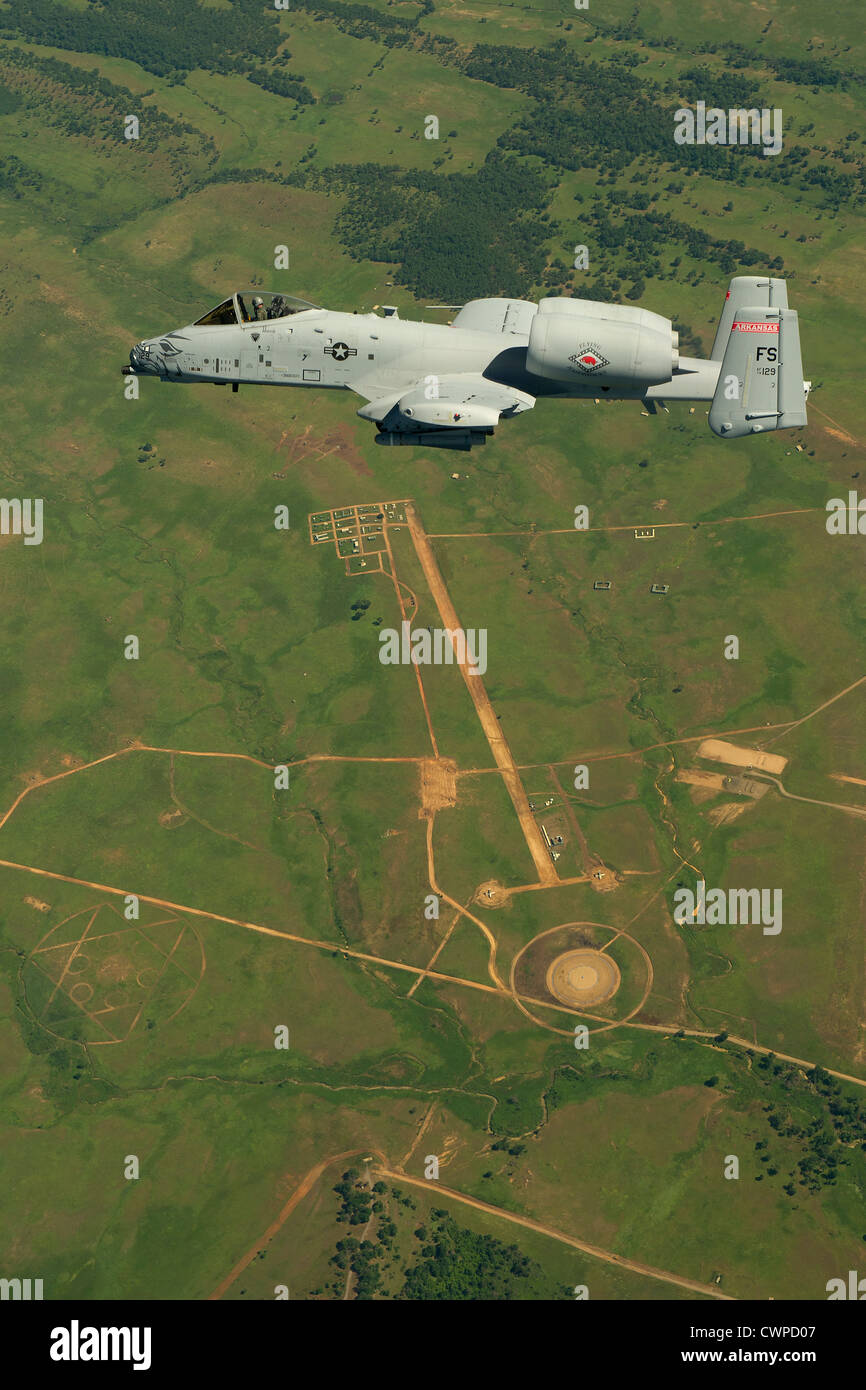 An A-10 Thunderbolt II banks into a high angle firing position during a ...