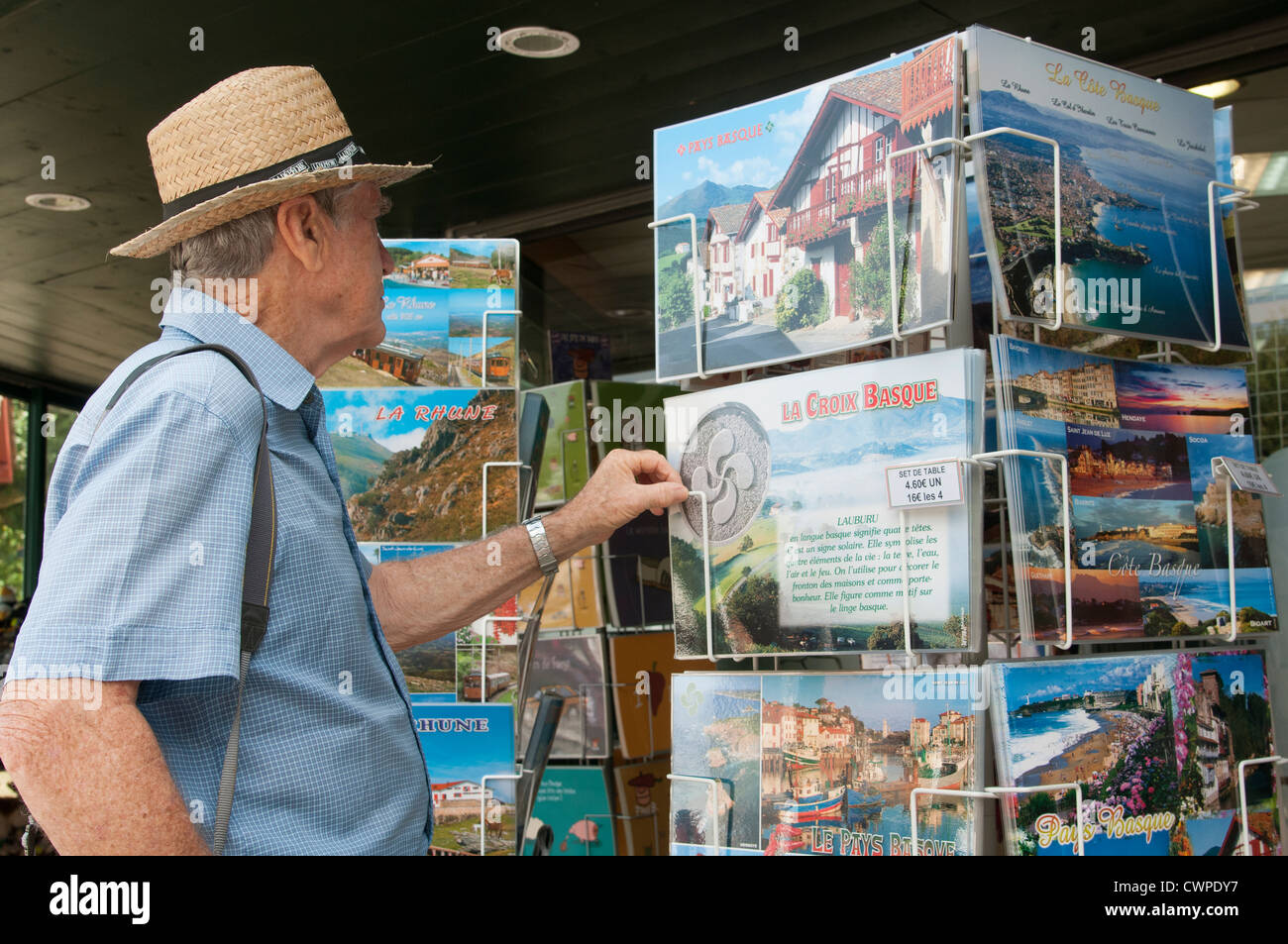Holidaymaker selecting giant size postcard Stock Photo - Alamy