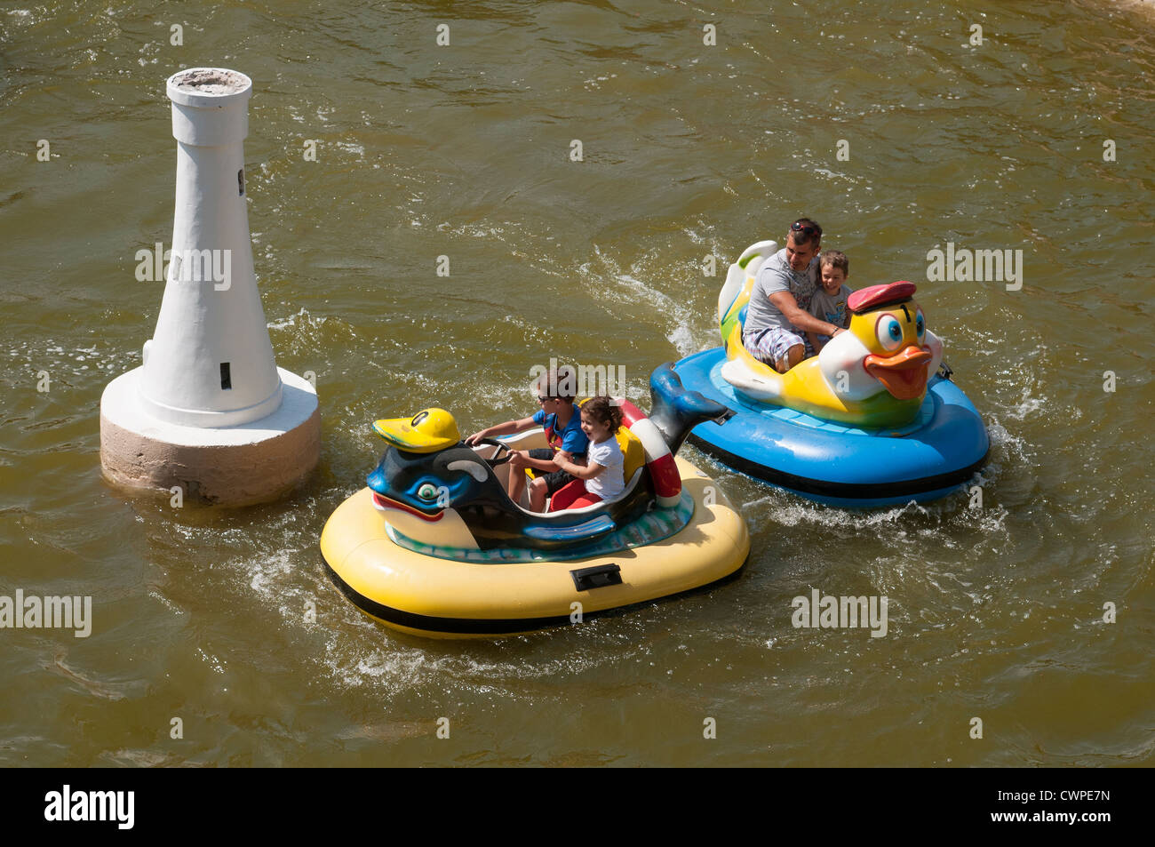 Children enjoy a inflatable boat ride around a model lighthouse San ...