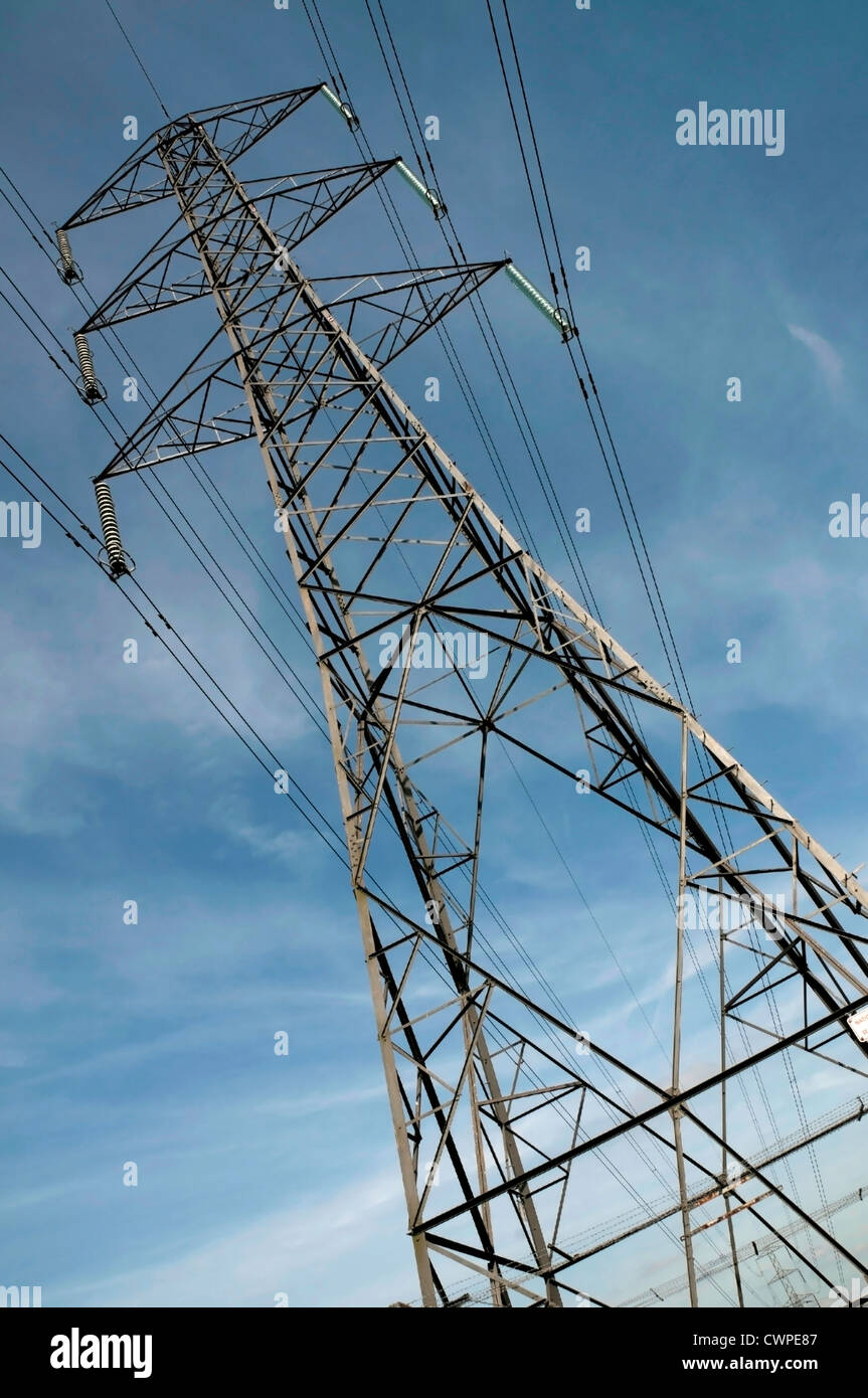 Seen from below an electric power pylon and wire against a blue sky ...