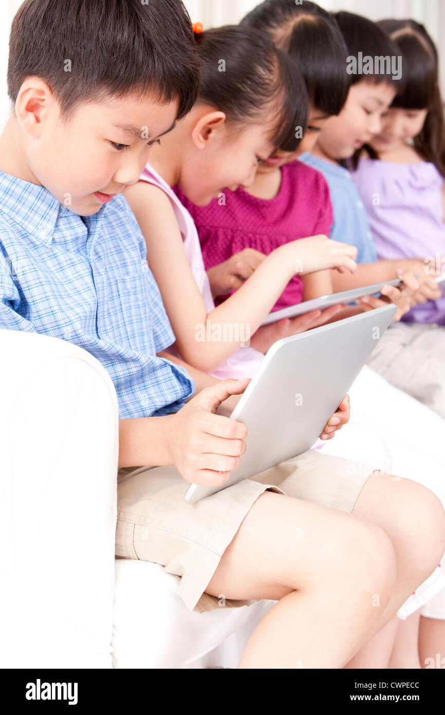 Children playing digital tablet at home Stock Photo - Alamy