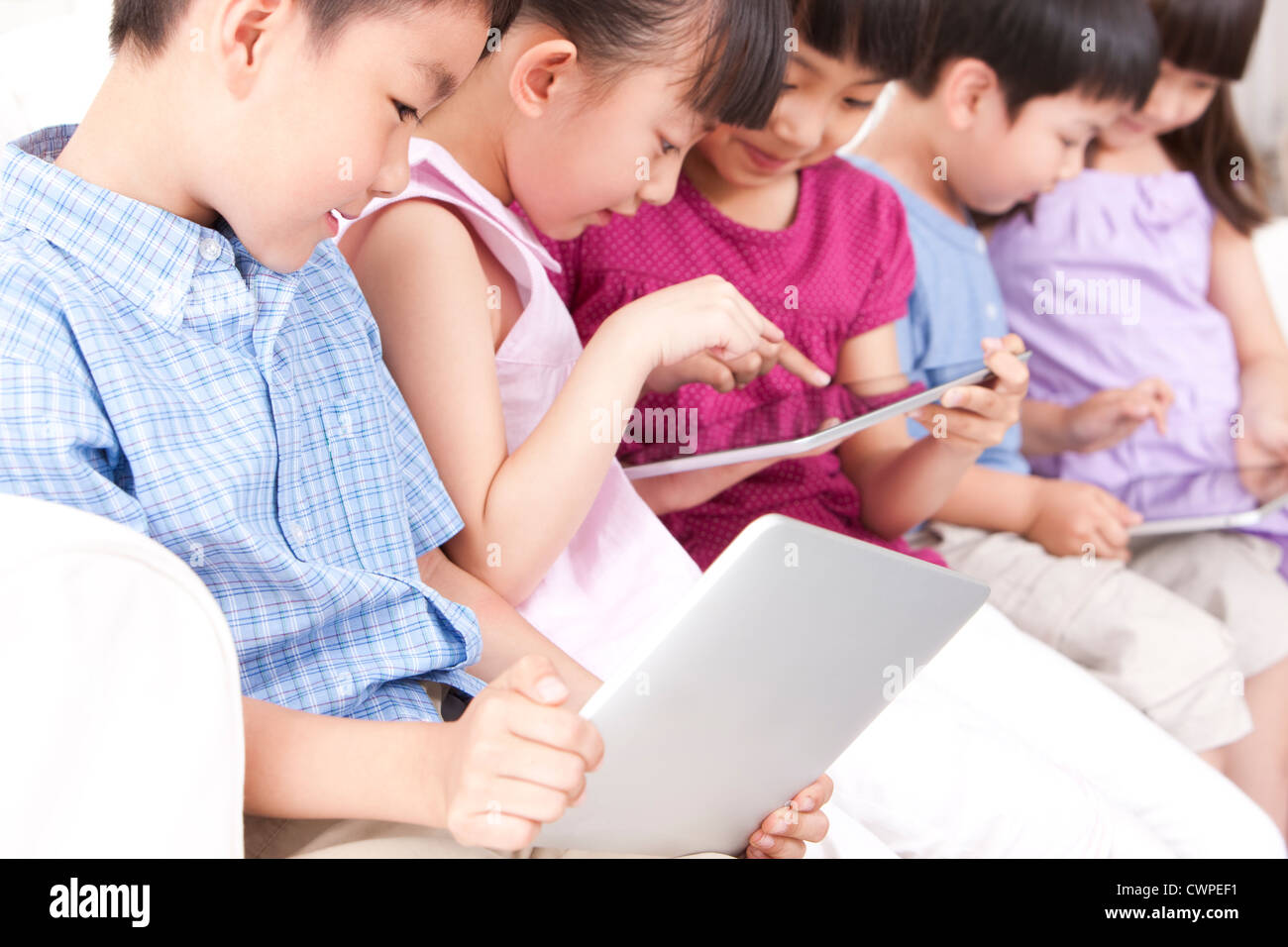 Children playing digital tablet at home Stock Photo - Alamy