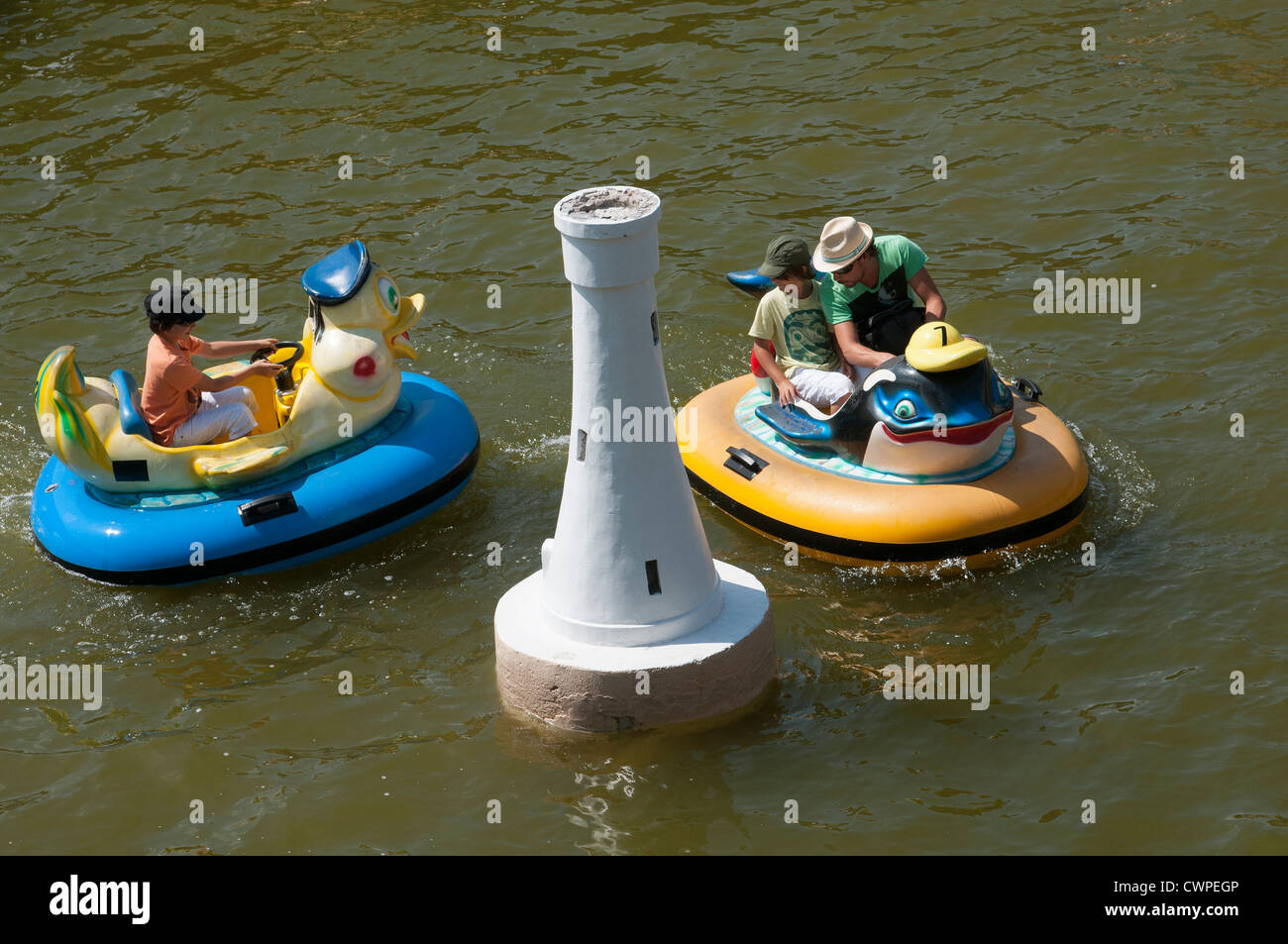 Children enjoy a inflatable boat ride around a model lighthouse San ...