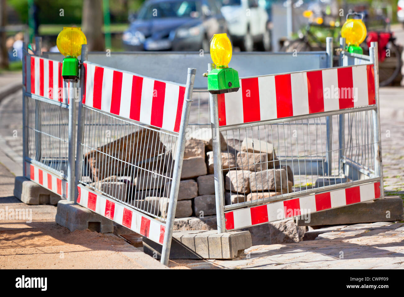Construction barriers on a street. Pavement repairing Stock Photo - Alamy