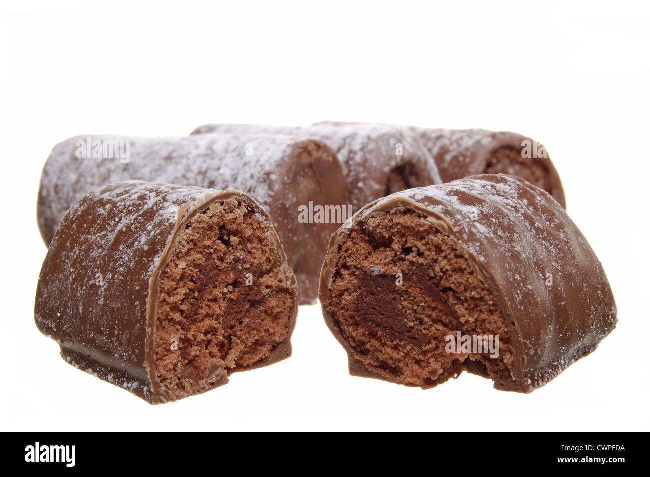 Chocolate logs dusted with icing sugar on a white background Stock ...