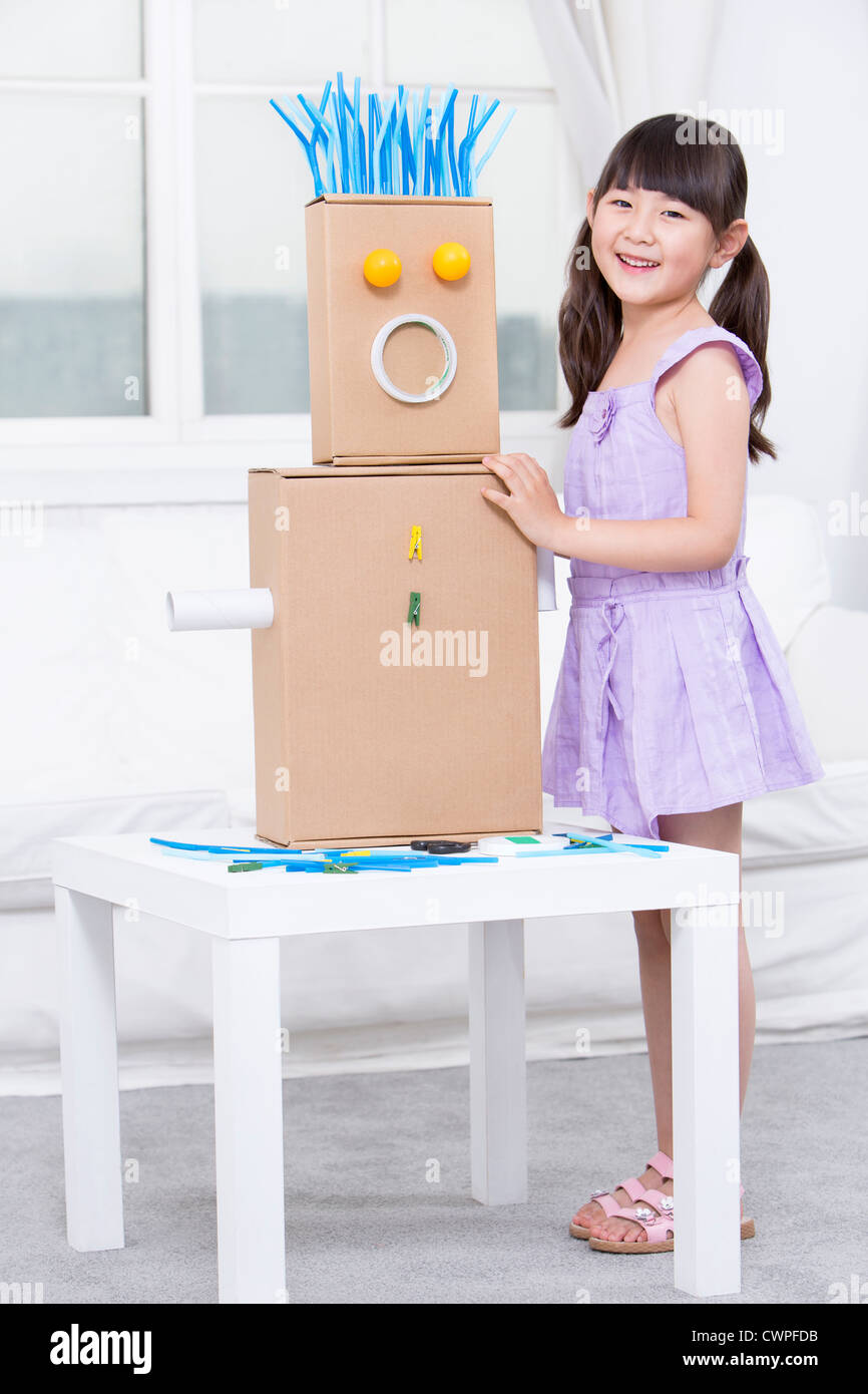 Girl and a DIY toy robot Stock Photo - Alamy