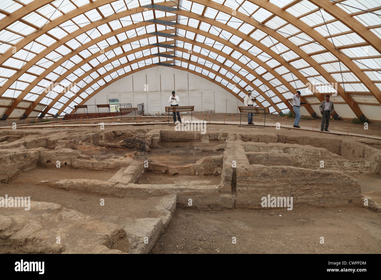 Local guide with Turkish visitors in early Neolithic site of Catalhoyuk ...