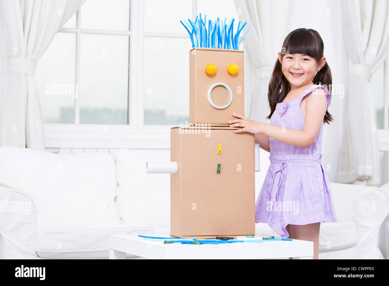Girl and a DIY toy robot Stock Photo - Alamy