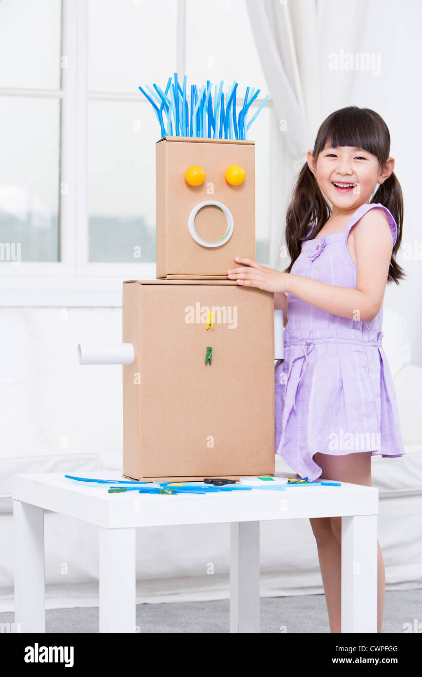 Girl and a DIY toy robot Stock Photo - Alamy