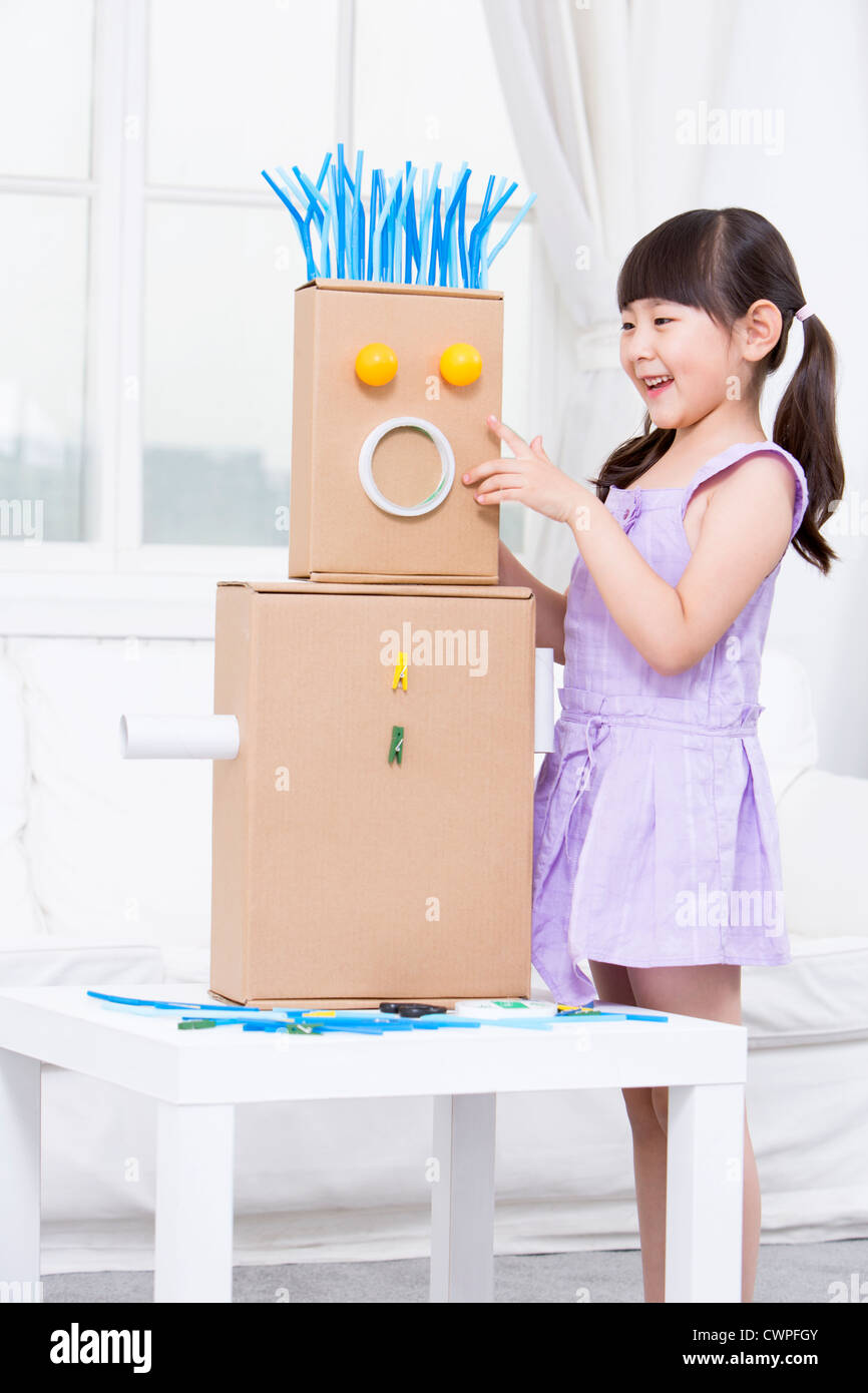 Girl and a DIY toy robot Stock Photo - Alamy