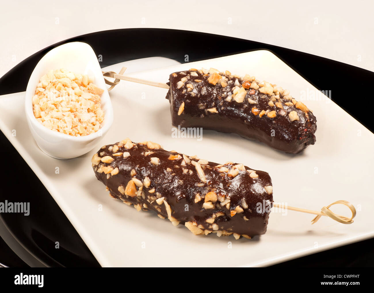 Chocolate coated bananas decorated with crunchy almond splinters Stock ...