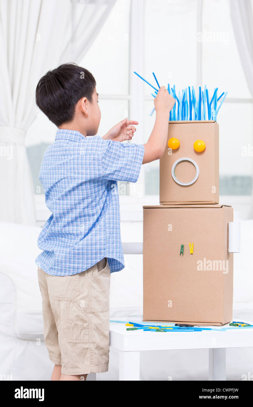 Boy making a toy robot Stock Photo - Alamy