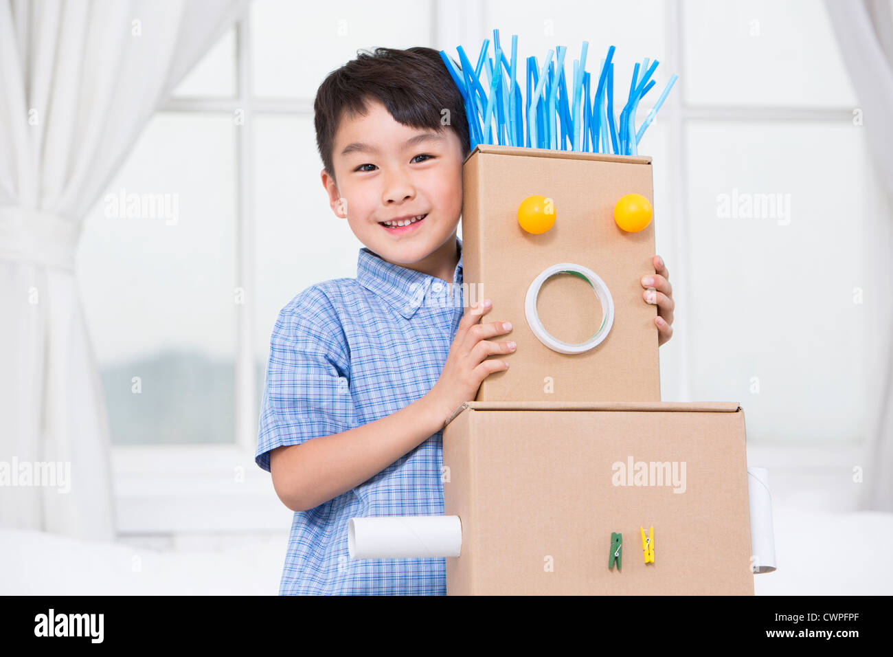 Boy and a handmade toy robot Stock Photo - Alamy