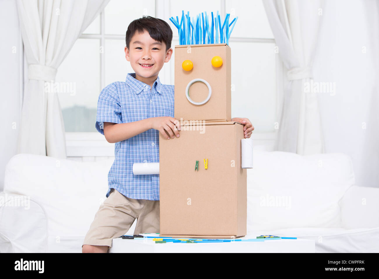 Boy and a handmade toy robot Stock Photo - Alamy