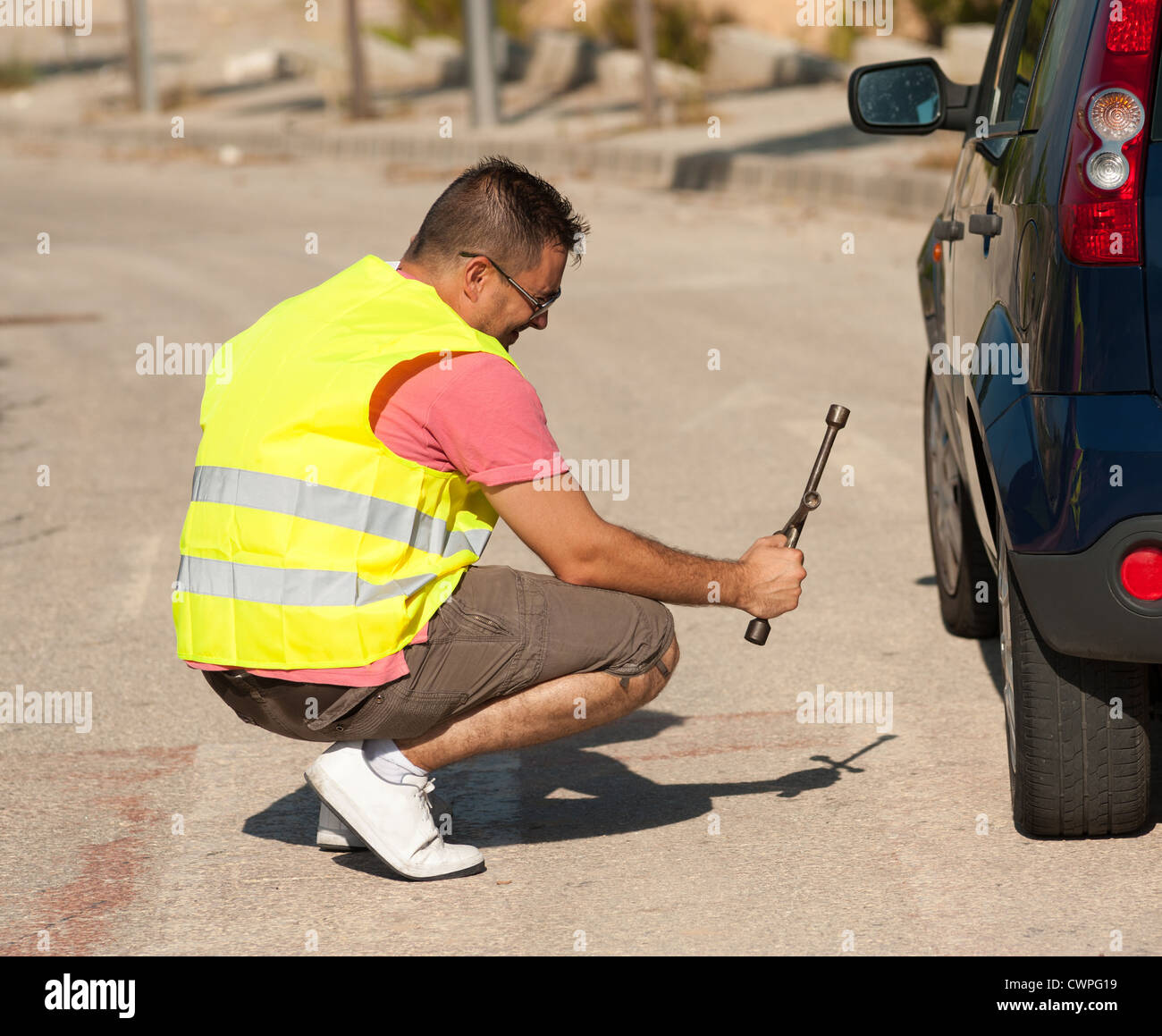 Guy completely unable to fix anything on his car Stock Photo - Alamy