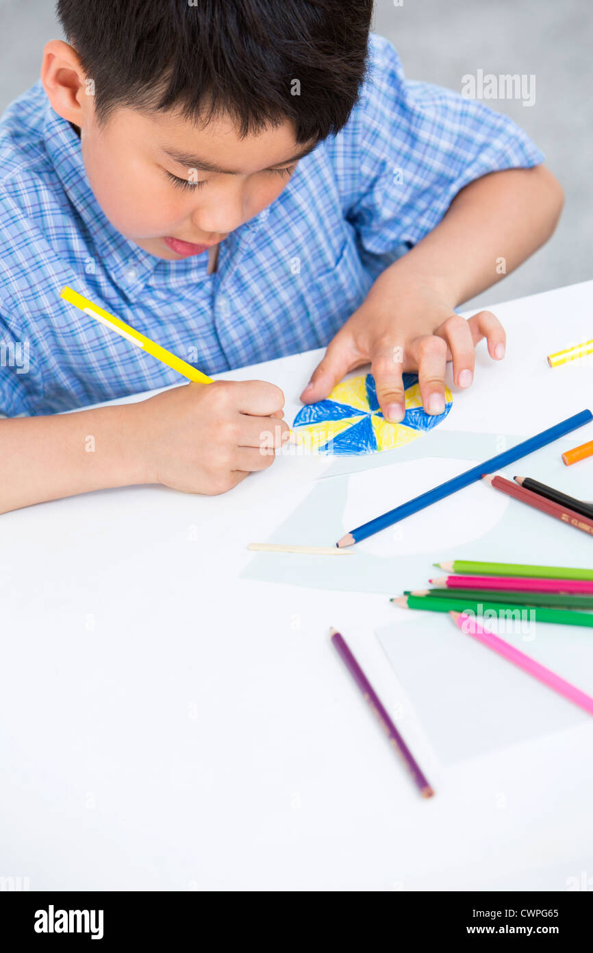 Boy making a paper toy Stock Photo - Alamy