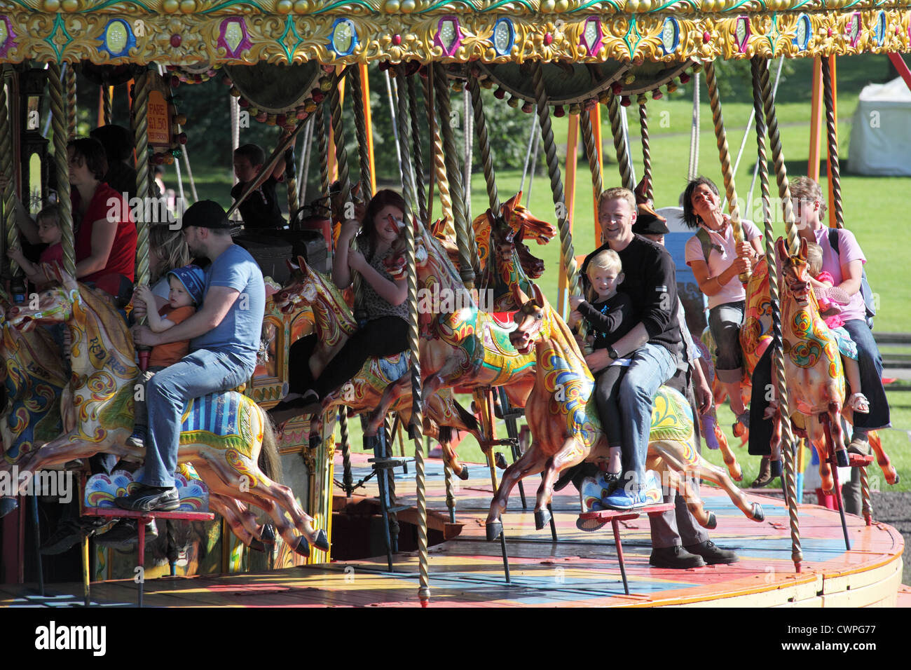 People enjoying a ride on the steam powered carousel at Beamish Museum ...