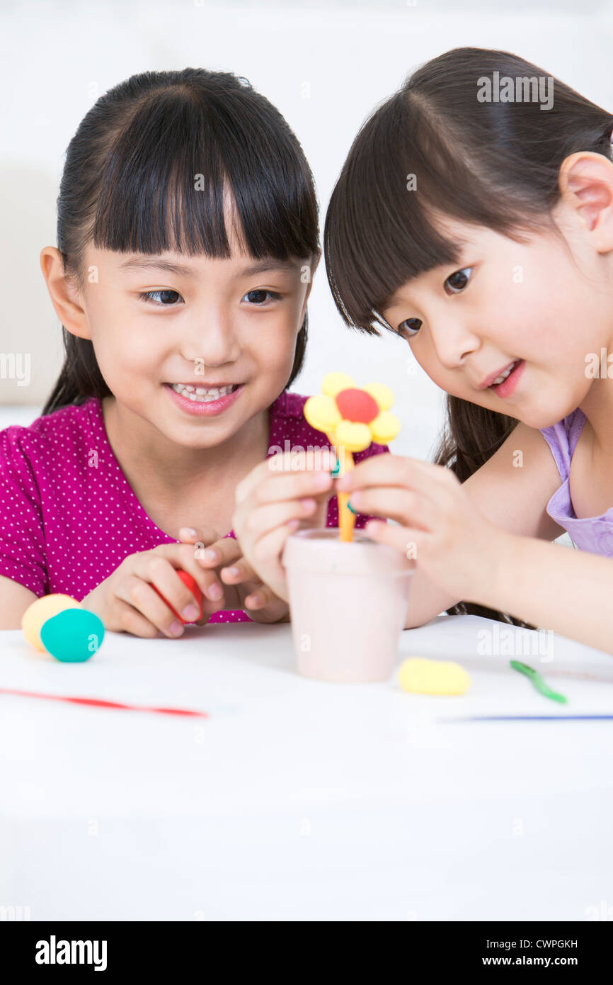 Girls playing child's play clay Stock Photo - Alamy