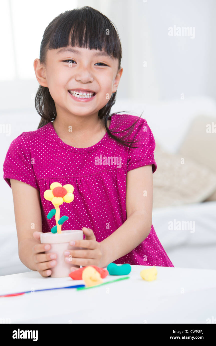 Girl playing child's play clay Stock Photo - Alamy