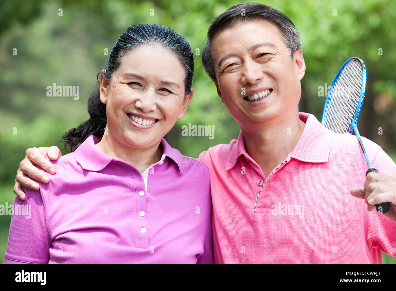 Happy couple playing badminton in park Stock Photo - Alamy