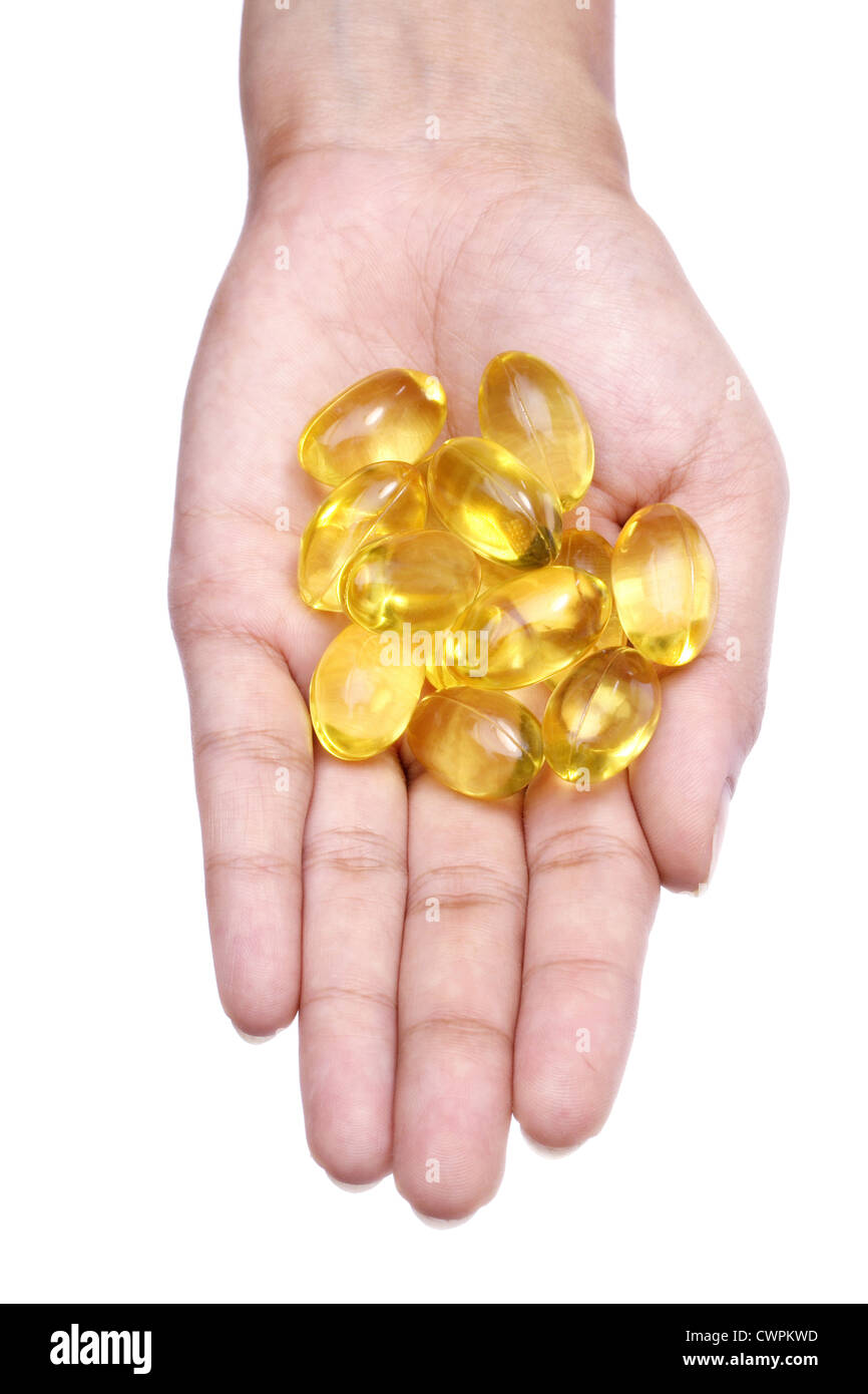 Cod liver oil pills in hand on white Stock Photo - Alamy