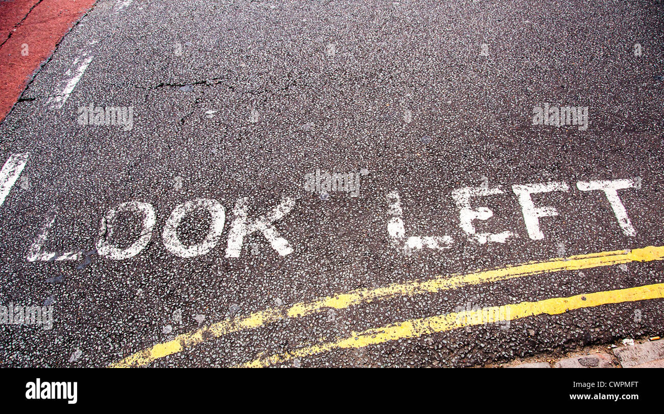Close up of road marking warning pedestrians to look left before ...
