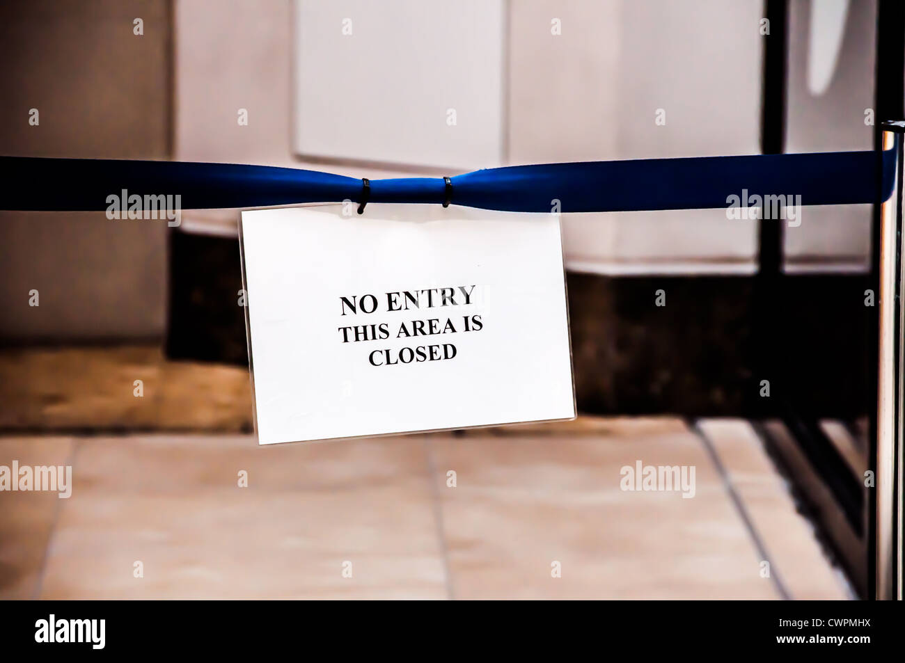 Sign for no entry on a pole tied with a blue ribbon Stock Photo - Alamy
