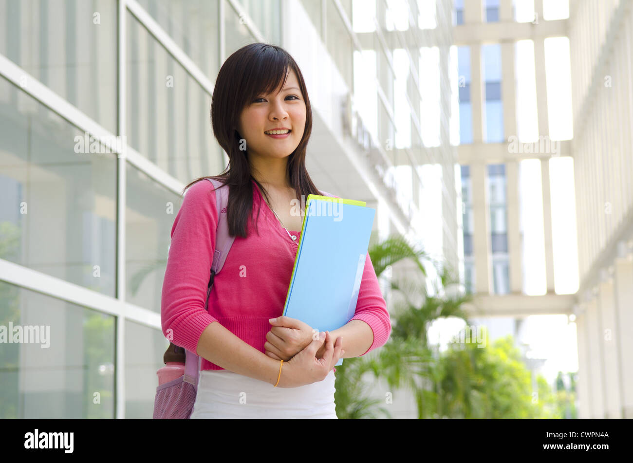 College Student standing outside college building Stock Photo - Alamy