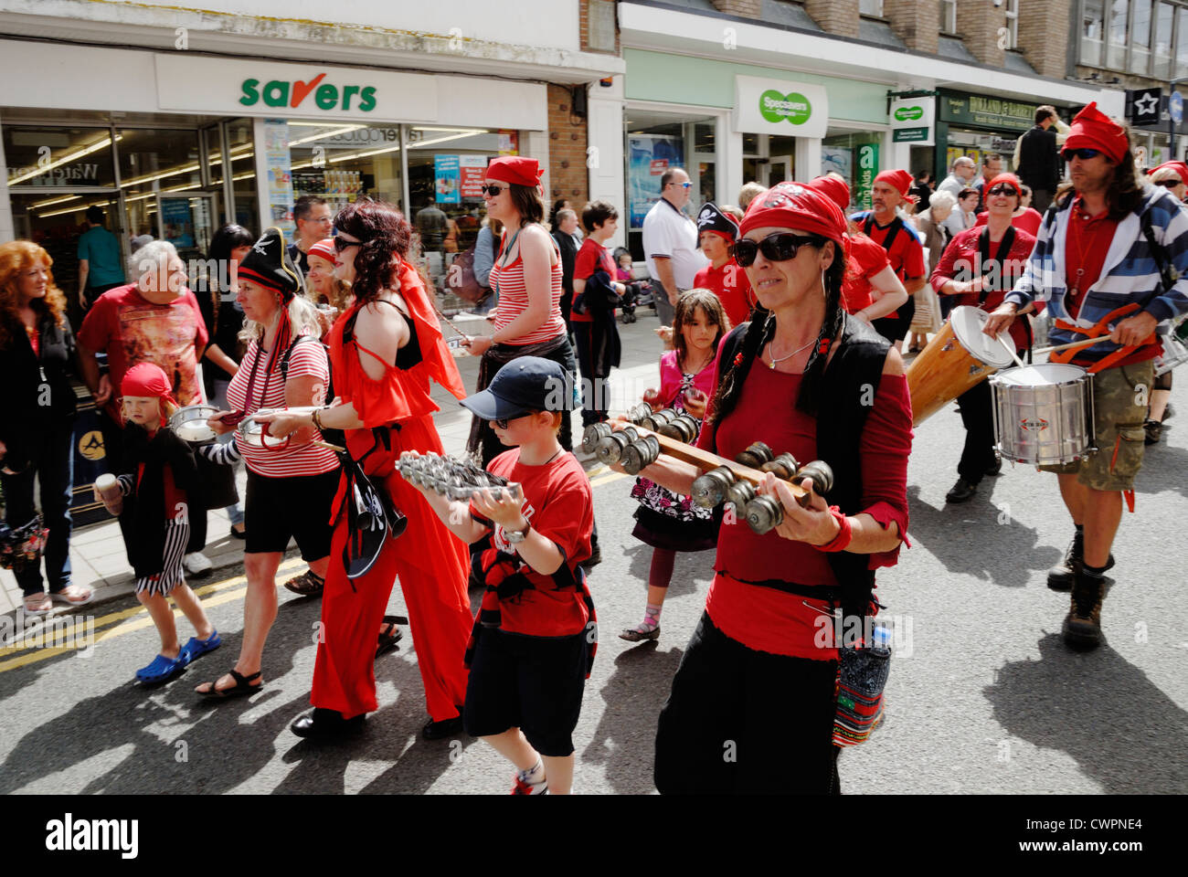 People dressed as pirates marching with musical instruments ...