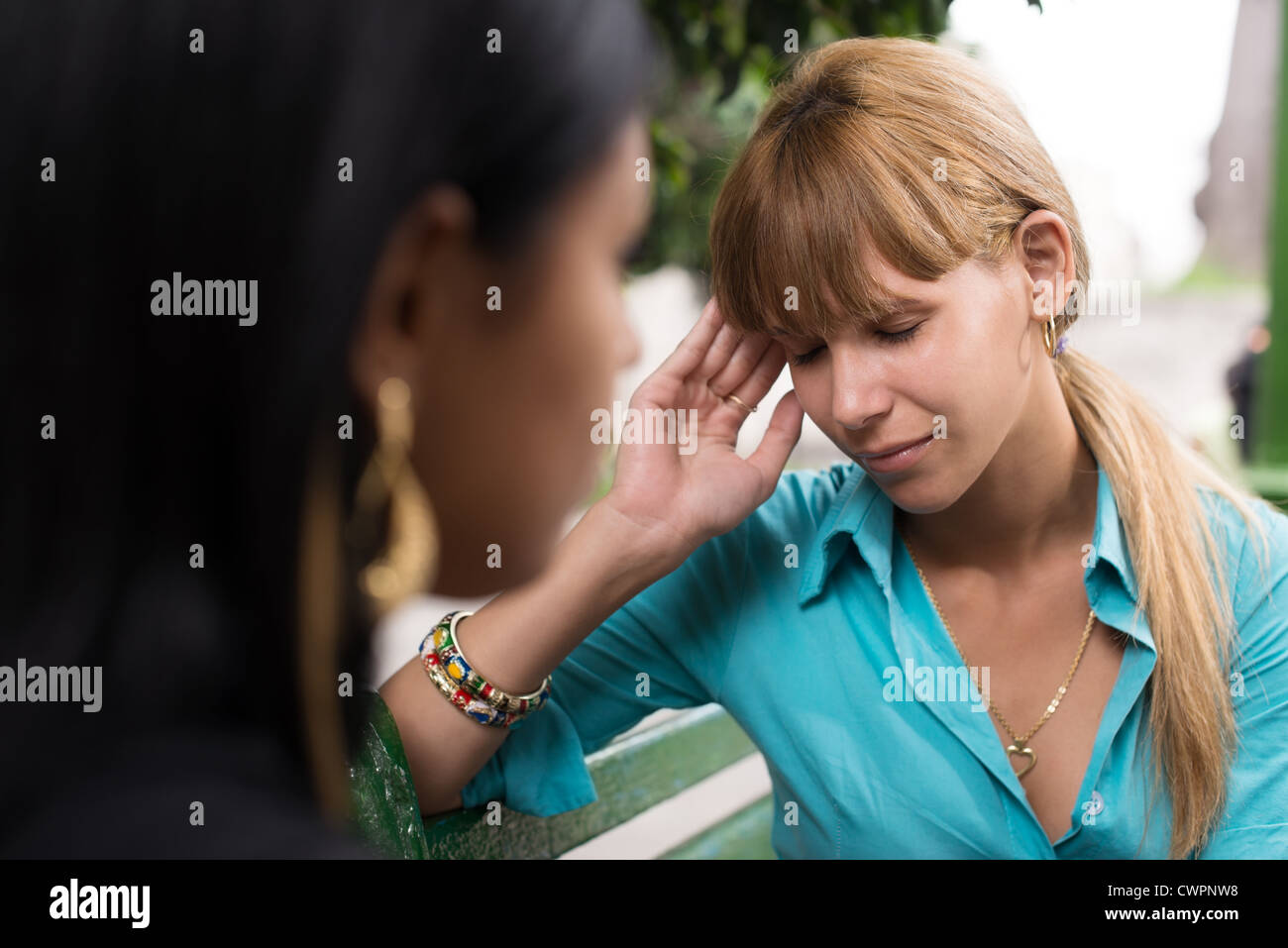 People and health, young woman feeling pain and talking with friend on ...