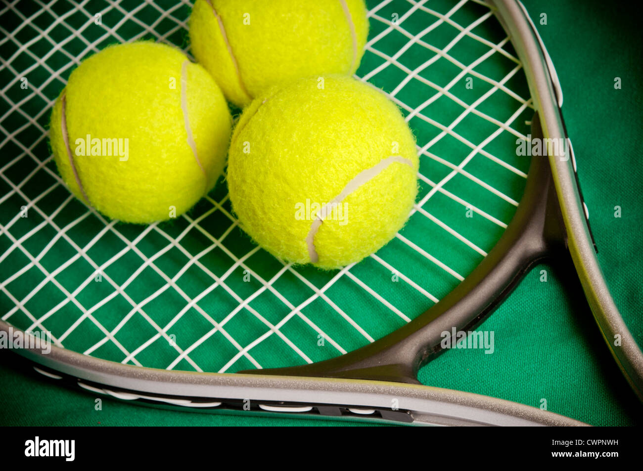 three tennis balls and racket Stock Photo - Alamy