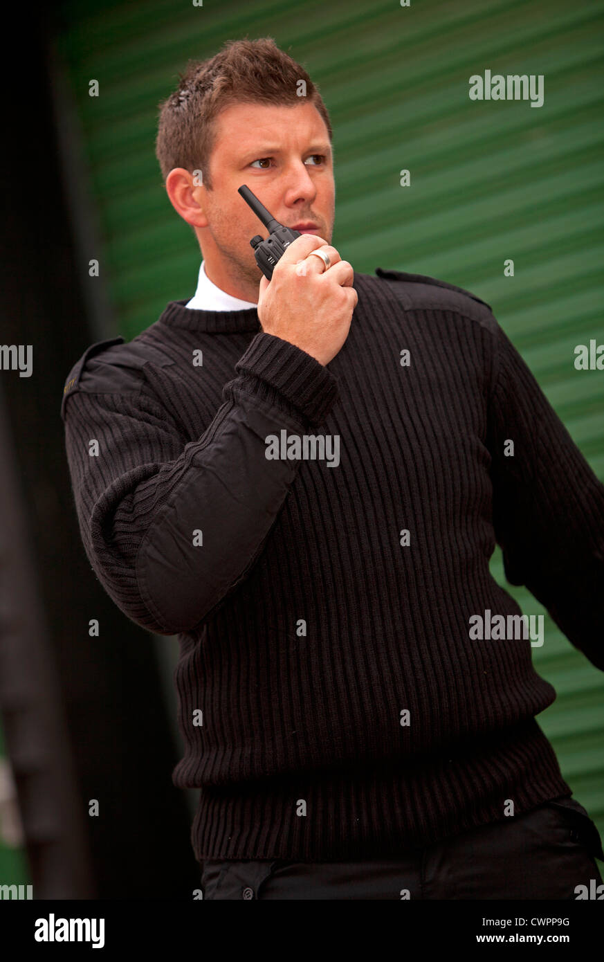 A security guard calling for back up on the radio Stock Photo - Alamy