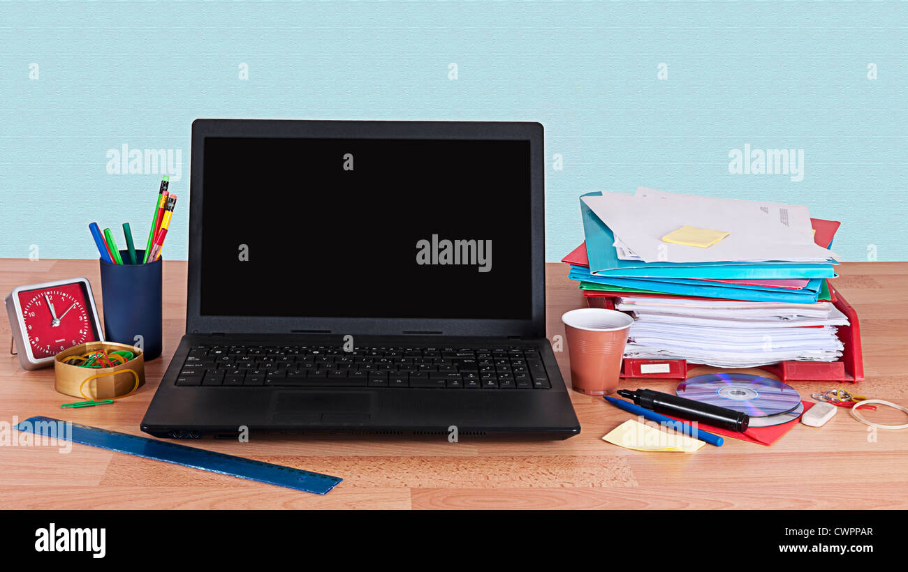Busy desk with laptop, files etc Stock Photo - Alamy