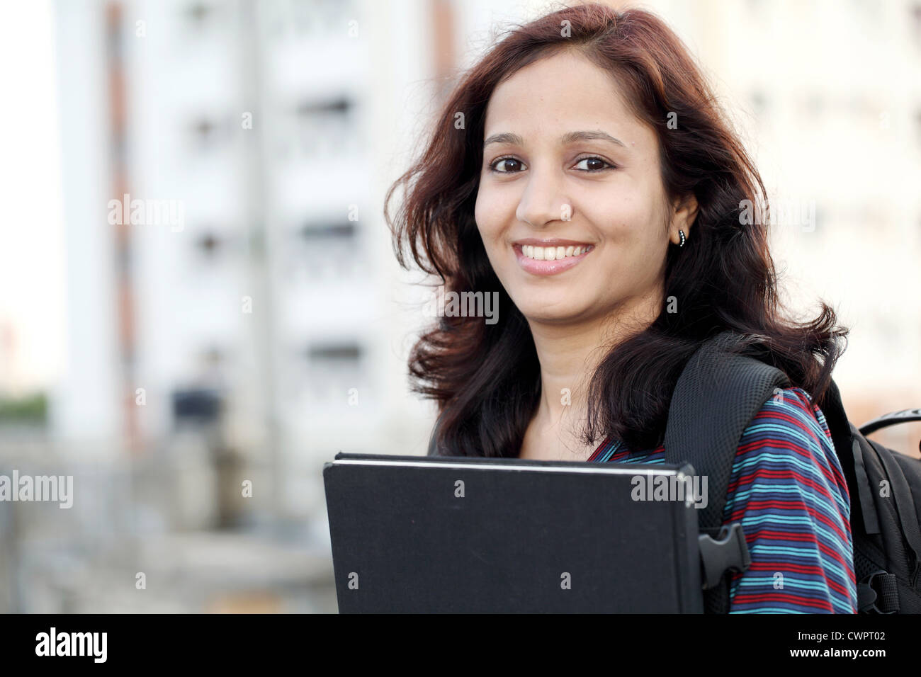 Smiling Indian female student holding books Stock Photo - Alamy