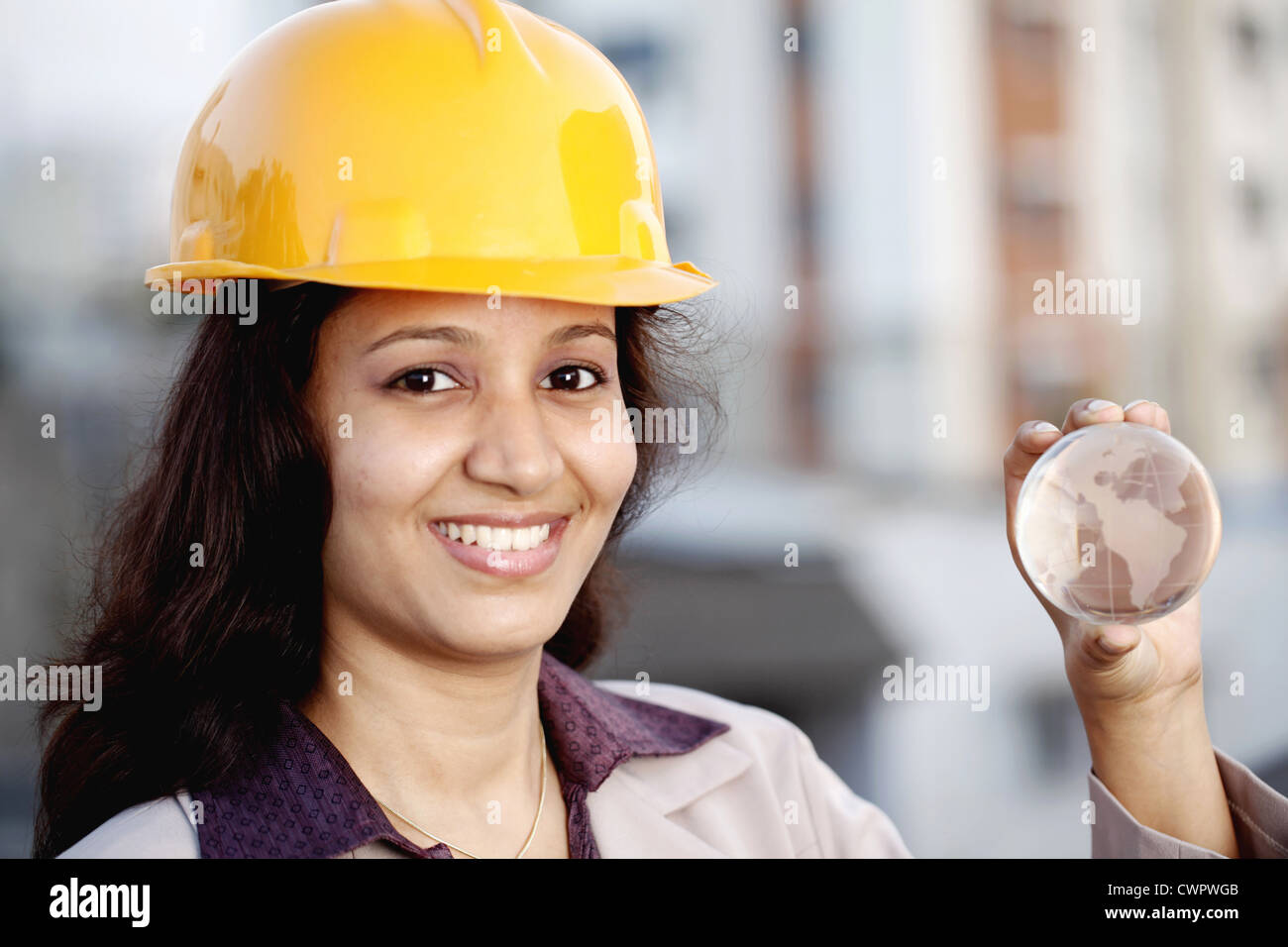 Indian female construction engineer holding a globe Stock Photo - Alamy