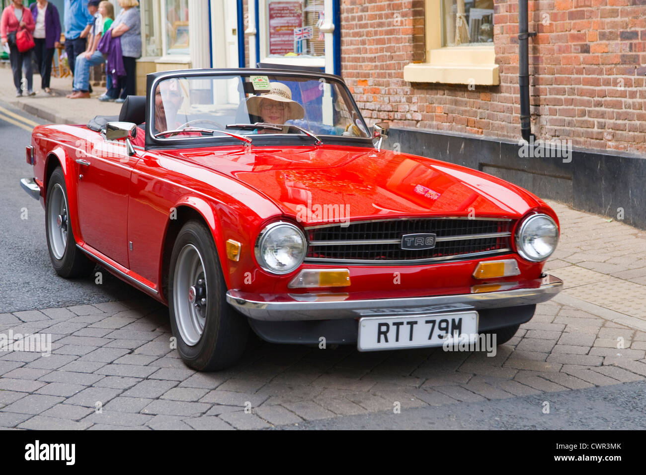 Red TR6 sports car in parade of vintage cars at opening of Bromyard Hop ...