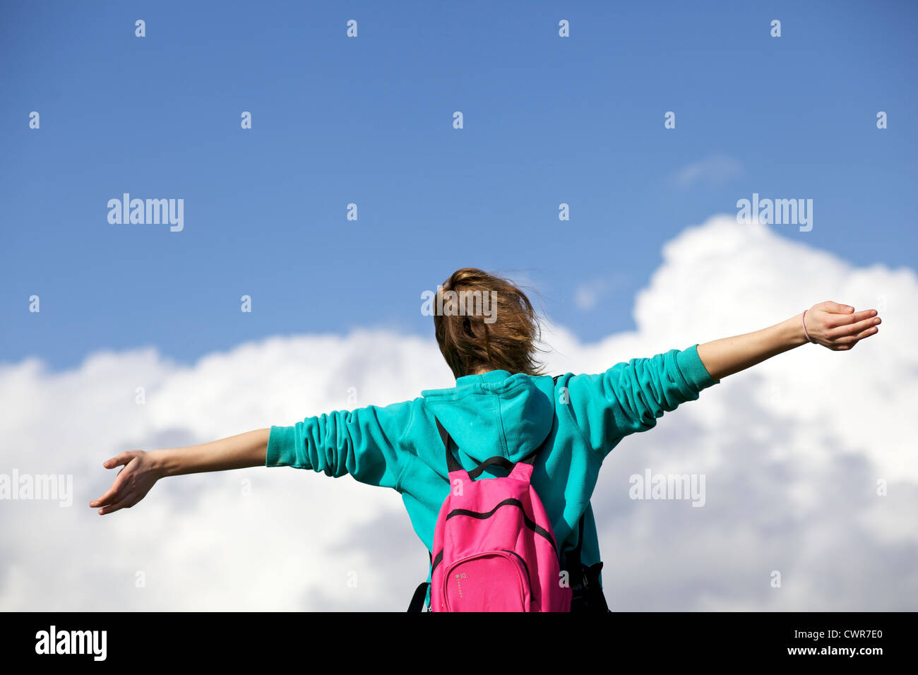 Girl walking forwards into big blue sky Stock Photo - Alamy