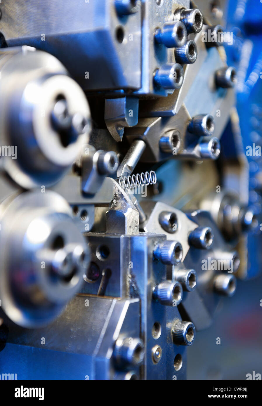 Industrial spring winder and chisels in a mechanical factory, making ...