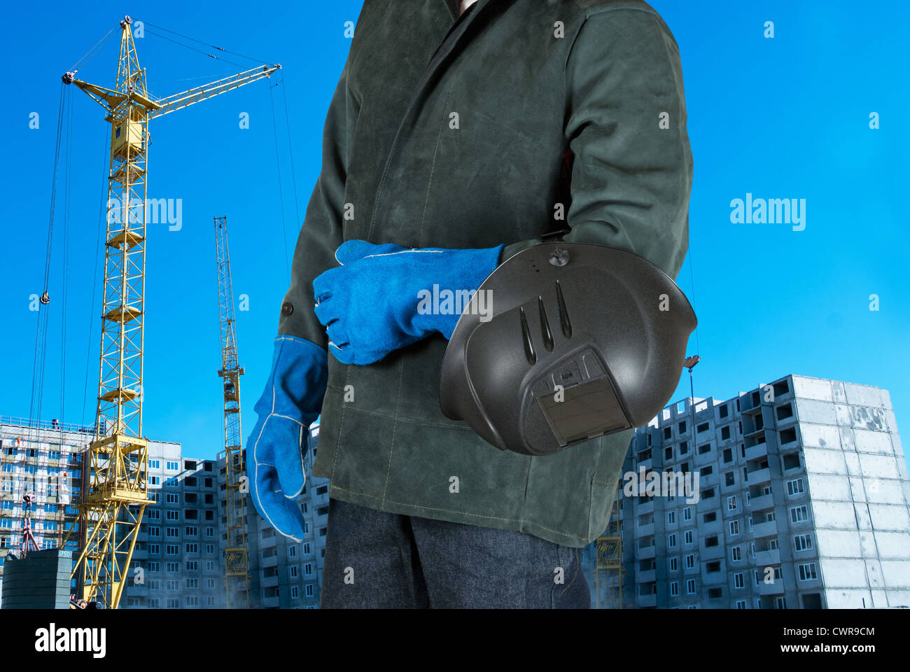male welder closeup with welding equipment on building background Stock ...