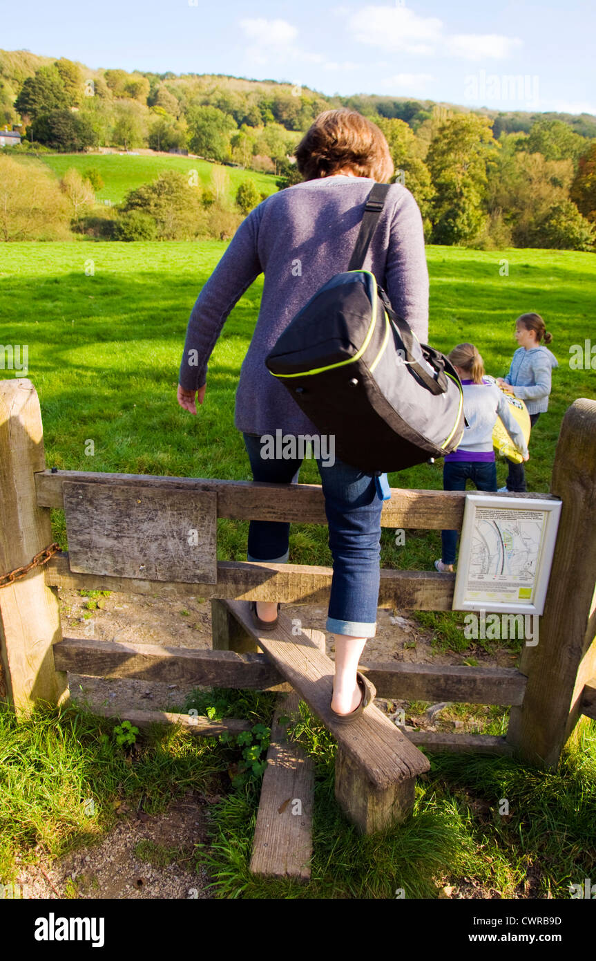 Woman climbing over gate hi-res stock photography and images - Alamy