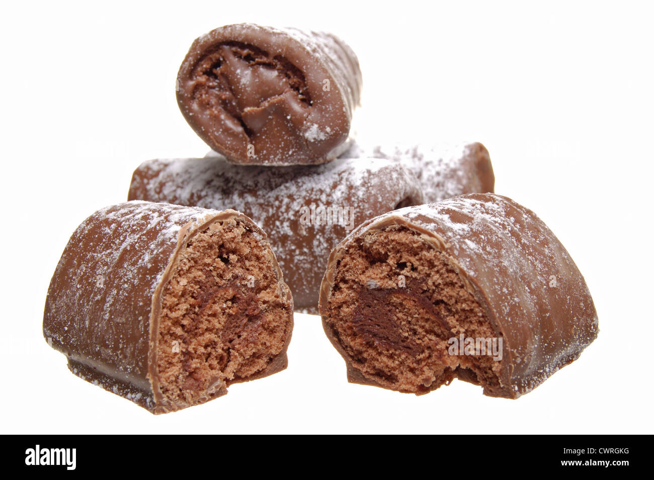 Chocolate logs dusted with icing sugar on a white background Stock ...