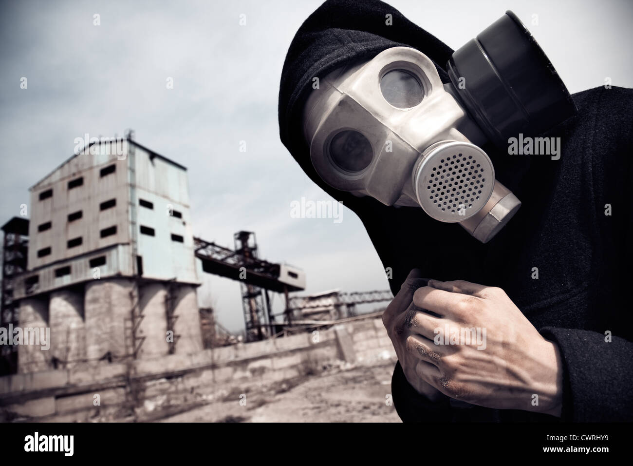 Human in gas mask outdoors and industrial factory on a background Stock ...