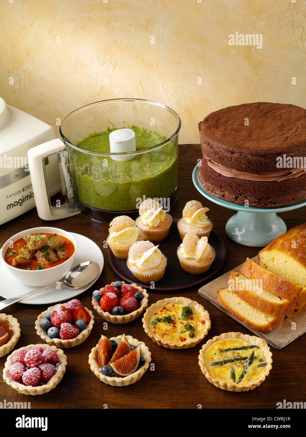 Food processor with cakes tarts and soup Stock Photo - Alamy