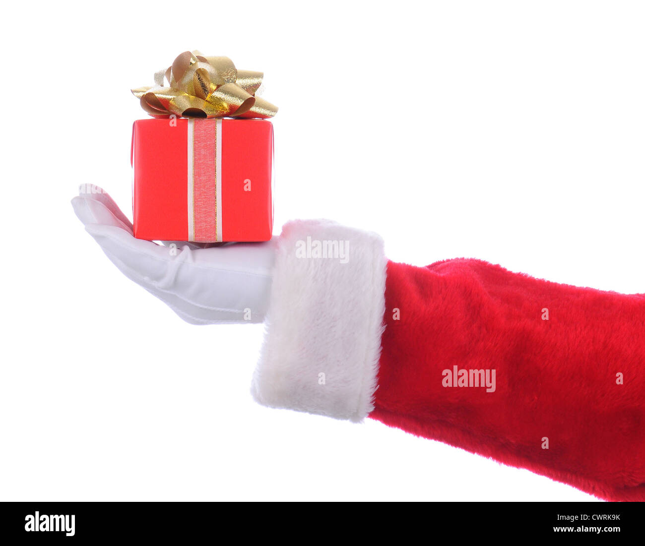 Santa Claus outstretched arm holding a red present with a gold bow in ...